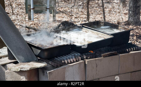Cooking maple syrup on an outdoor barrel stove Stock Photo - Alamy