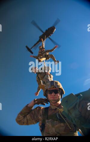 U.S. Army Ranger soldiers fast rope from a USA UH-60 Black Hawk ...