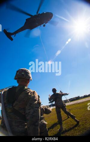 U.S. Army Ranger soldiers fast rope from a USA UH-60 Black Hawk ...
