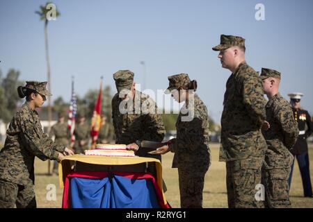 U.S. Marine Corps Col. David Everly presents a commemorative plaque to ...