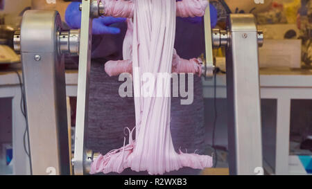 Making purple salt water taffy in small candy shop Stock Photo - Alamy