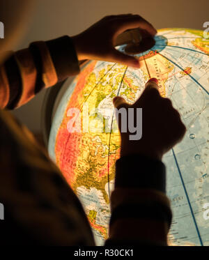 looking for a location on an earth model map Stock Photo - Alamy