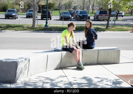 Two girls sit opposite each other Stock Photo - Alamy