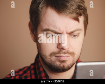 Young emotional man with pda looking down at camera Stock Photo - Alamy