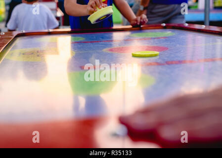 Hand holding a stick to hit disc in the table air hockey game Stock ...