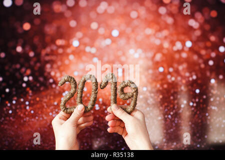 2019 numbers in hands and bokeh background. Christmas and happy new ...
