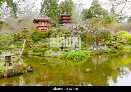 Japanese style garden with moon gate rocks shrubs and trees design by ...