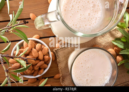 Almond drink in a glass cup on a wooden table. Horizontal composition ...