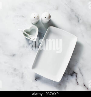 empty dishes on the marble table, copy space Stock Photo - Alamy