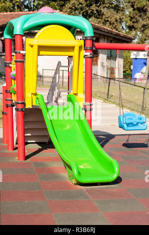 Blue and red metal slide in a park for children Stock Photo - Alamy