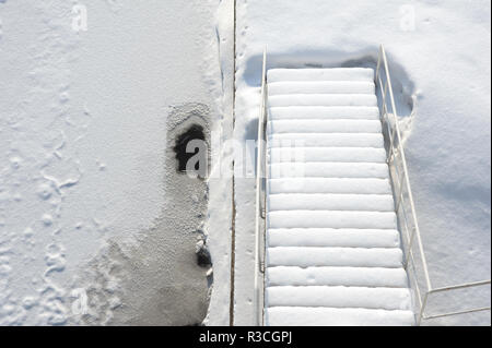 Snow covered slippery concrete stairs. First snow on granite stone ...
