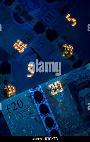 Banknote under ultraviolet light showing security features invisible in ...