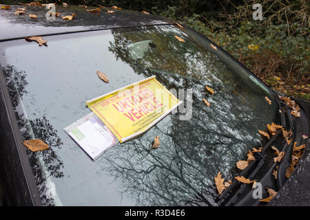 Untaxed vehicle sticker on the windscreen of a car immobilised at the ...