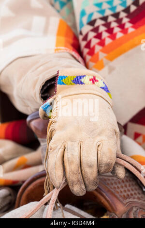 USA, Wyoming, Shell, Cowboy and Cowgirl Riding along Red Rock Cliffs ...