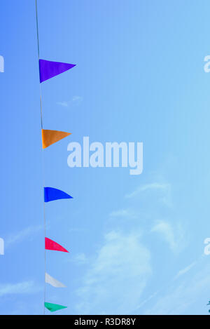 Colorful pennants with sky background to place text Stock Photo - Alamy