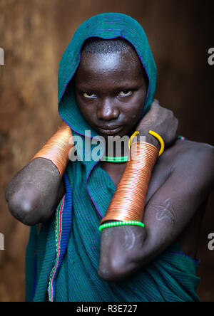 Portrait of young Suri / Surma woman with ritual scarification on chest ...