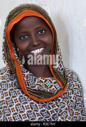 Portrait of a veiled smiling afar tribe girl with sharpened teeth, Afar ...