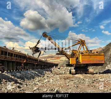 Loading of iron ore on the train in career Stock Photo - Alamy
