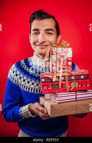 Studio shot of a man in Icelandic sweater giving his girlfriend gift ...