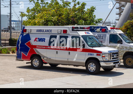 An AMR (American Medical Response) ambulance drives through an ...