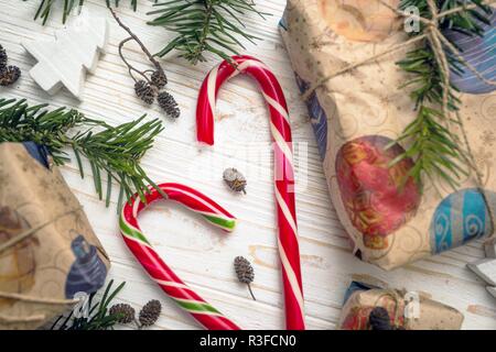Christmas backgrounds. Gifts and candy caner on the wooden background ...