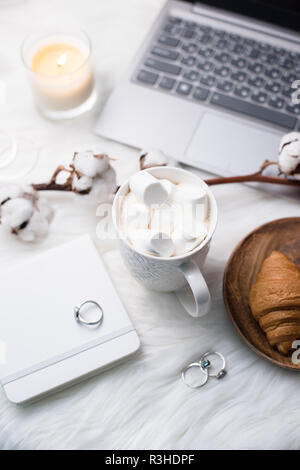 Cozy winter bloggers white work space with laptop, coffee with ...