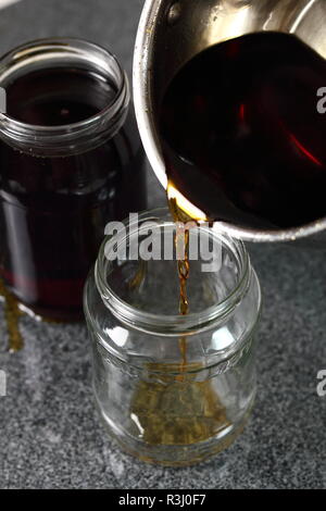 Pouring Treacle Syrup into Jar Stock Photo - Alamy