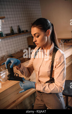 serious female detective investigating evidence at crime scene Stock ...