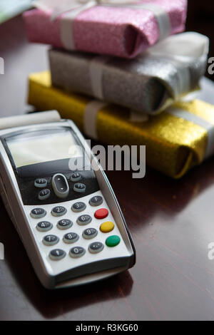 Payment terminal and gift boxes Stock Photo - Alamy