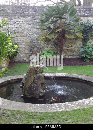 ancient fountain with statues and pond with fish Stock Photo - Alamy