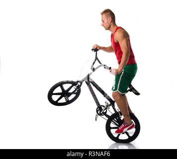 Side view of handsome muscled young man pulling something isolated on ...