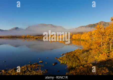 Autumn color reflects into Maskinonge Lake in Waterton Lakes National ...