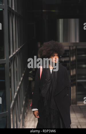 Young hipster woman walking away on side road alone Stock Photo - Alamy