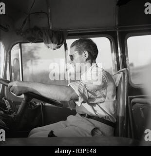 1950s, historical, a male coach driver sitting with his hands on ...