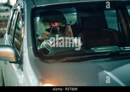 Spaceman driving car at night Stock Photo - Alamy