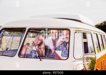 Carefree friends inside a van Stock Photo - Alamy
