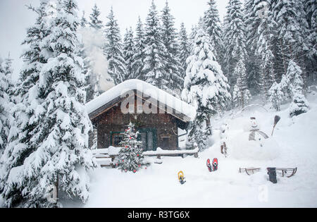 Austria, Altenmarkt-Zauchensee, snowman, sledges and Christmas tree at ...