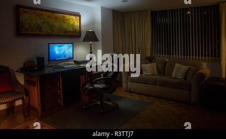 Room illuminated by a computer screen at night, no people. Empty ...