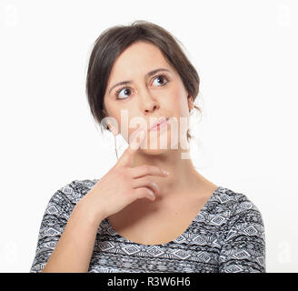 Beautiful brunette young woman holding honey in shock face, looking ...