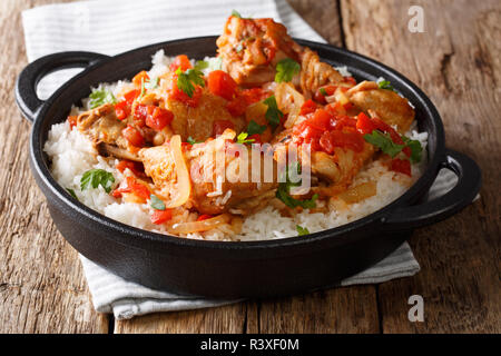 Haitian stewed Chicken (poulet creole) with rice closeup on the pan ...