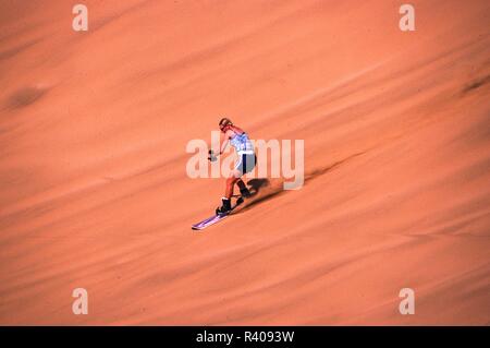 NAMIBIA Tourists sand surfing Stock Photo - Alamy