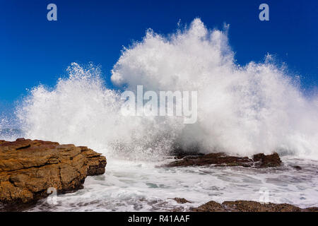 Wave rocks crashing exploding white ocean sea water spray power into ...