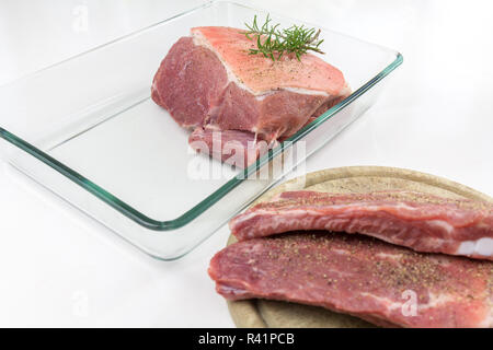 Piece of roast beef braised in red wine with thyme garnish on a cutting ...