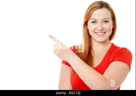 Charming female model pointing away Stock Photo - Alamy