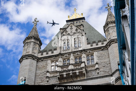 An airplane flying over the Tower Bridge of London,UK. Airplane low ...