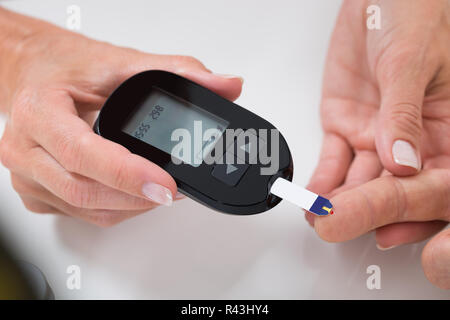 Doctor Measuring Sugar Reading Of Patient With Glucometer Stock Photo ...