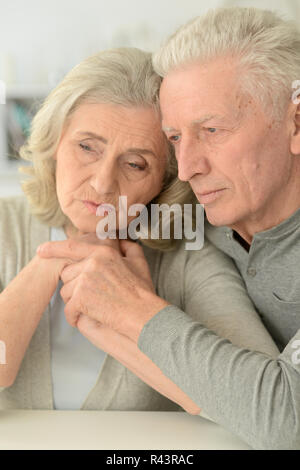Portrait of sad senior couple posing at home Stock Photo - Alamy