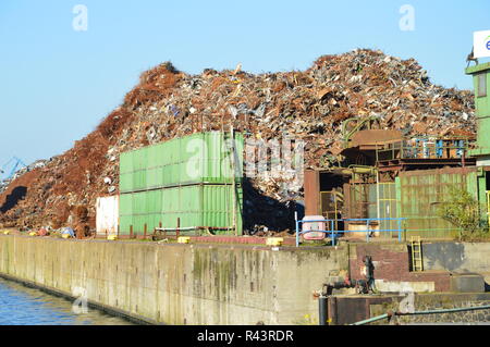 Scrap metal recycling loading into containers top view from the throne ...