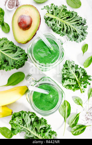 green smoothie in bottle and spirulina algae powder and pills in glass ...