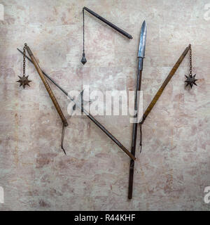 Medieval weapons on a stone wall. Cool background Stock Photo - Alamy